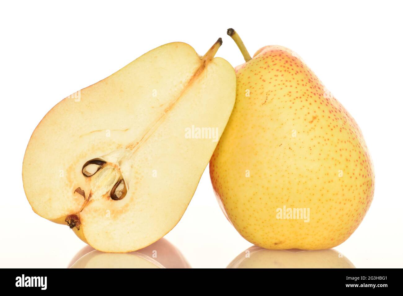 One whole and half a juicy pear, close-up, on a white background Stock ...