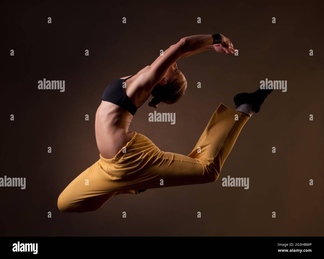 Beautiful woman jumping in the splits Stock Photo - Alamy