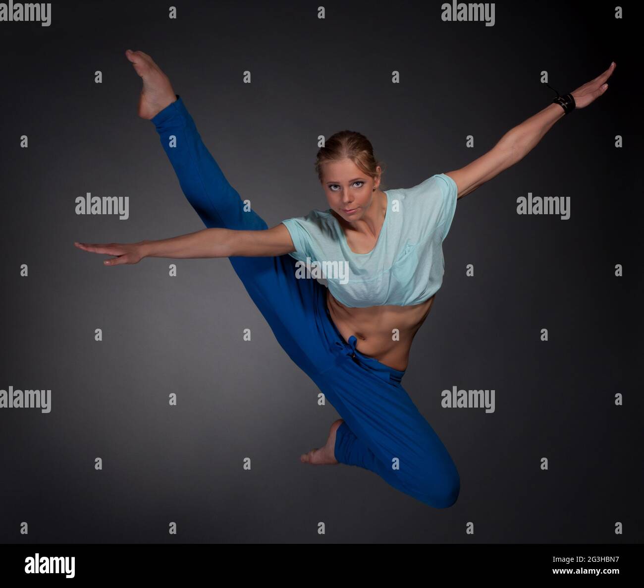 Beautiful woman jumping in the splits Stock Photo - Alamy