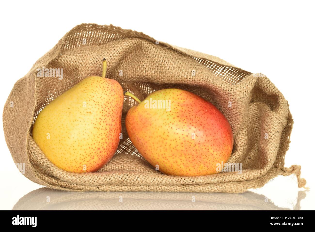 Two organic yellow-red pears in a jute bag, on a white background Stock ...