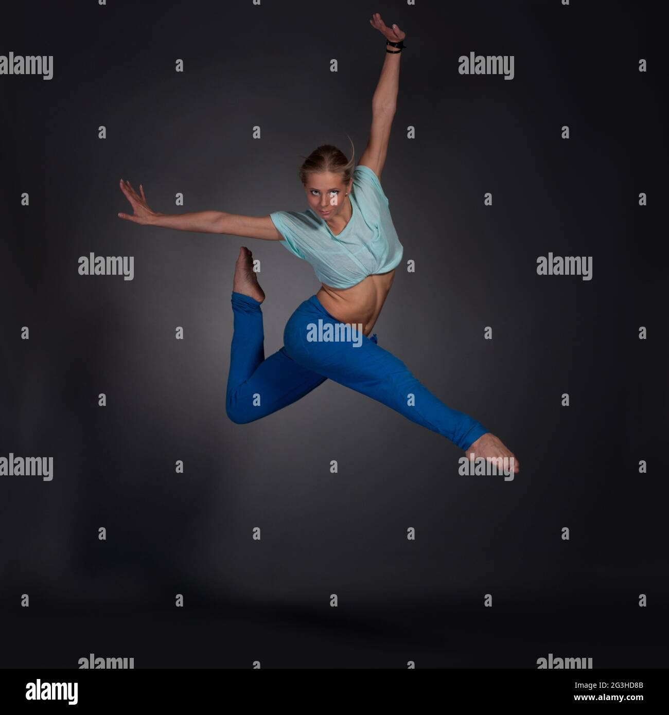 Beautiful woman jumping in the splits Stock Photo - Alamy