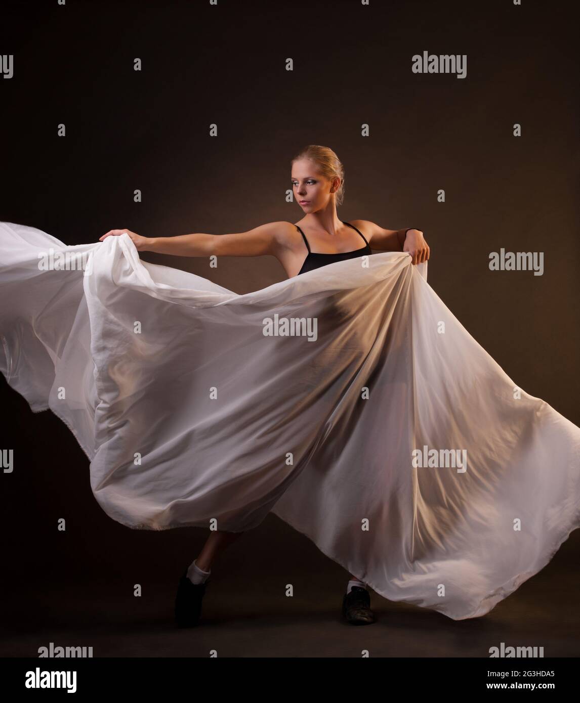 Beautiful woman in motion holding fabric Stock Photo - Alamy