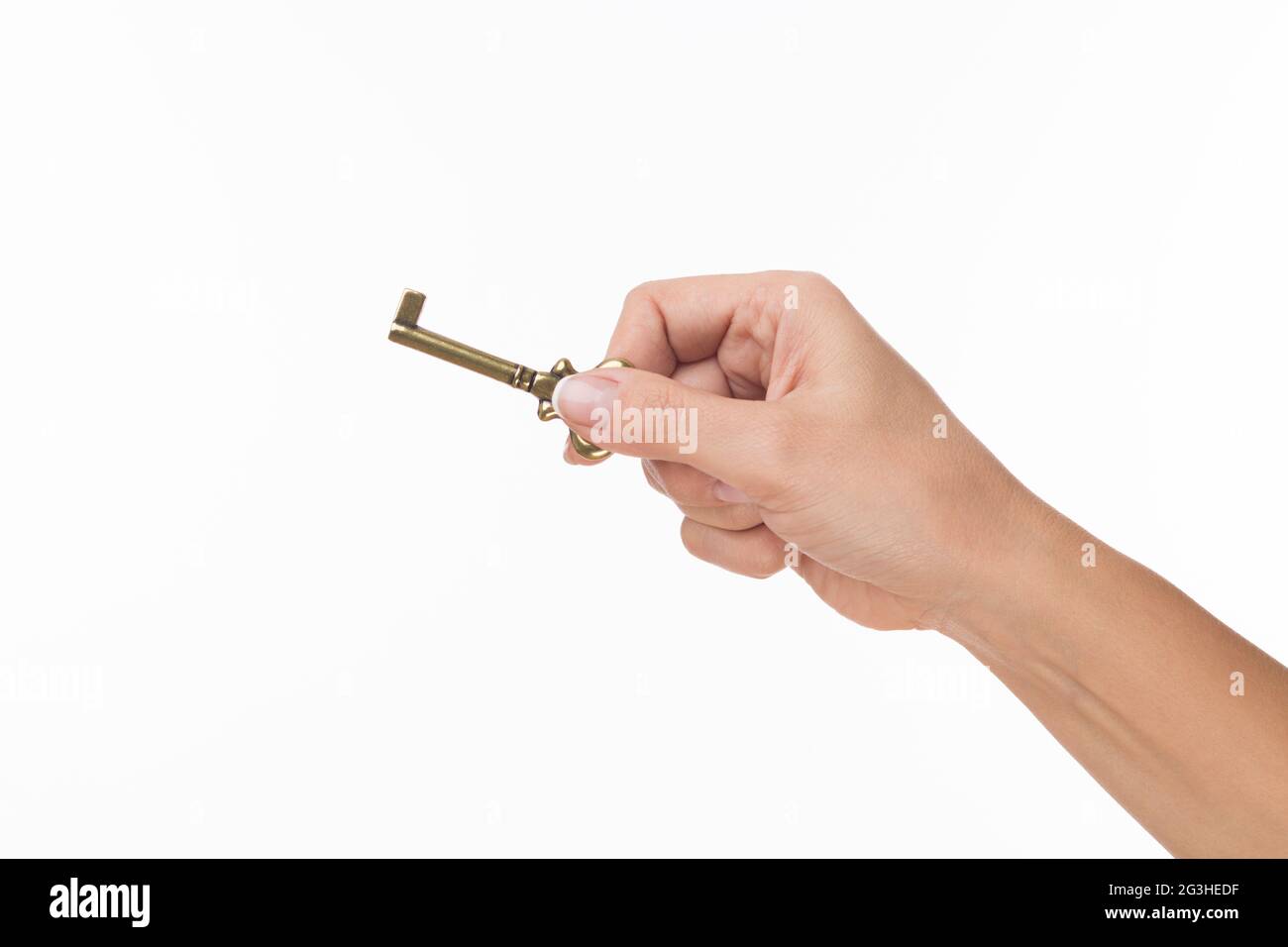 Hand with old key Stock Photo - Alamy