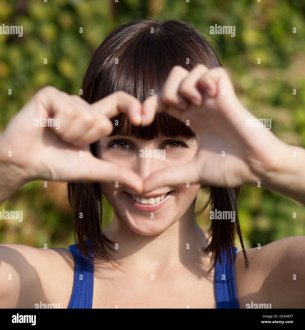 Beautiful girl show love sign Stock Photo - Alamy