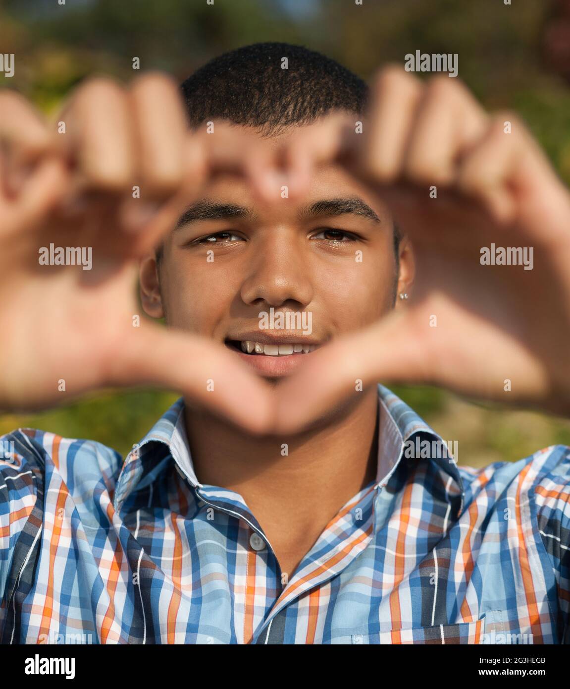 Young man show love sign Stock Photo - Alamy