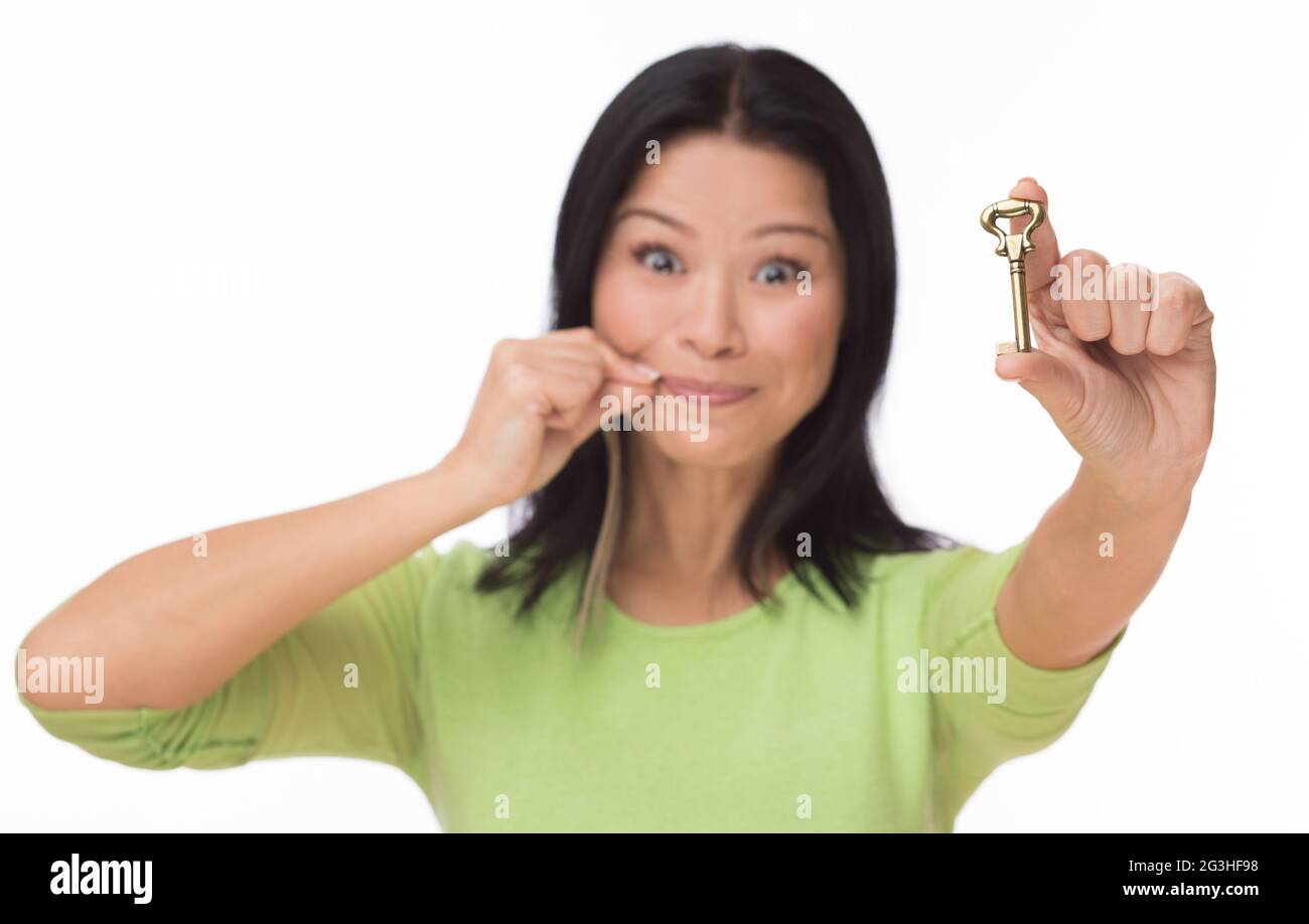 Woman locked mouth with key on white Stock Photo - Alamy
