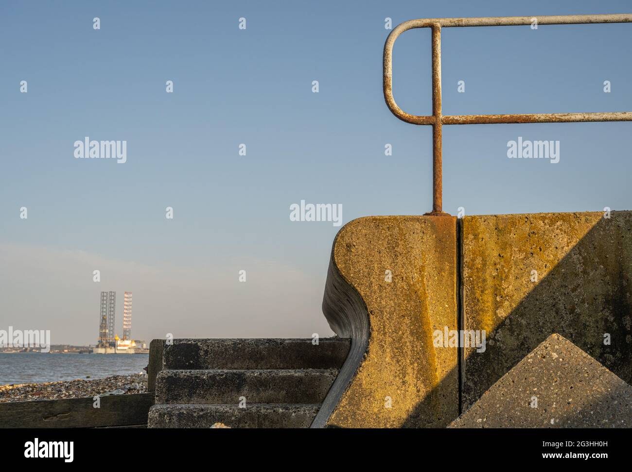 The seafront at grain looking towards the port of Sheerness, with oil ...