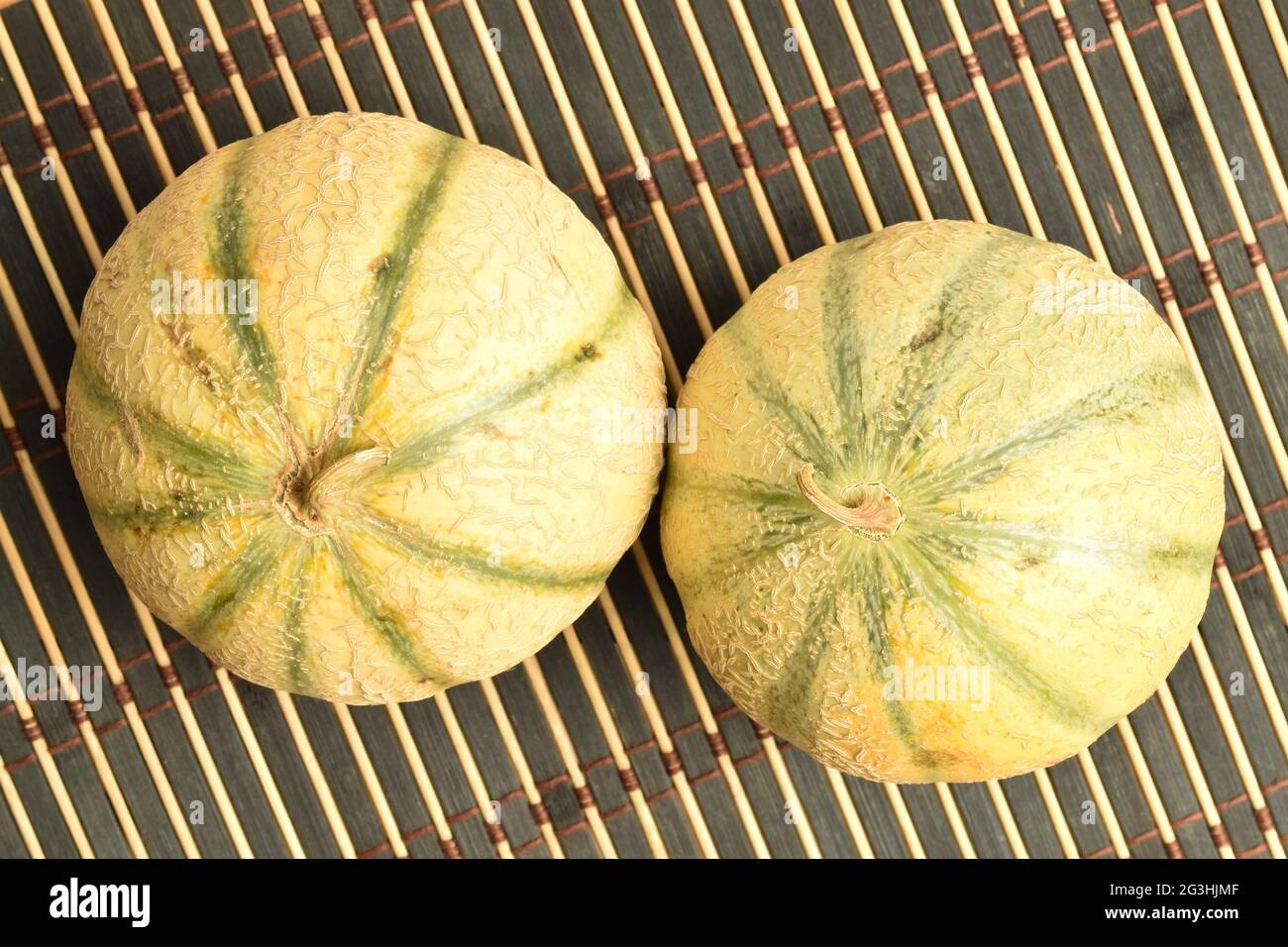 Two fragrant organic melons on a bamboo mat, close-up, top view Stock ...