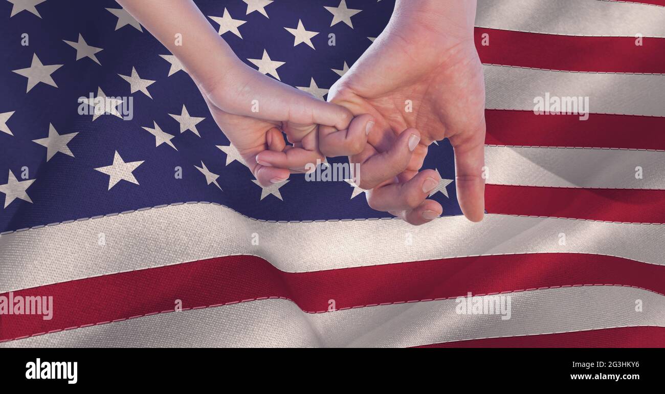 Composition of two hands linking little fingers, making pinkie promise ...