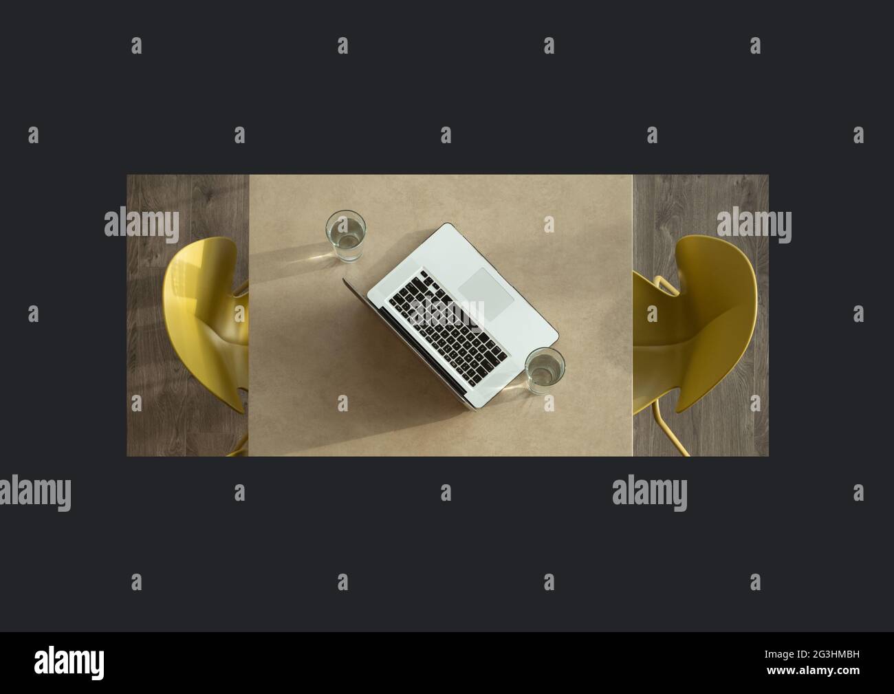 Composition of overhead table with laptop, two drinks and two chairs ...