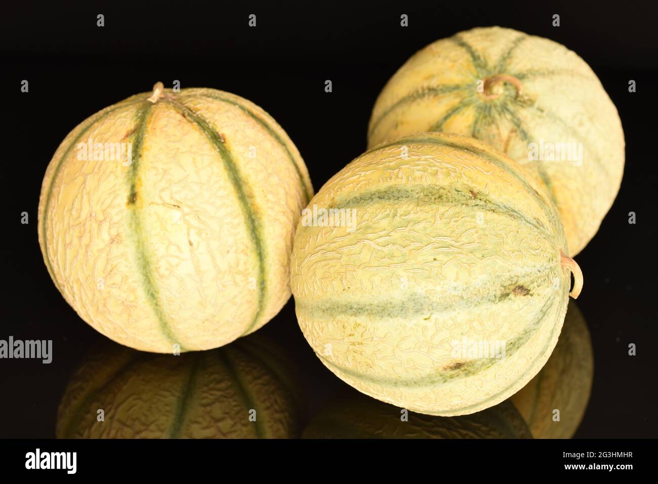 Three organic sweet melons, close-up, on a black background Stock Photo ...