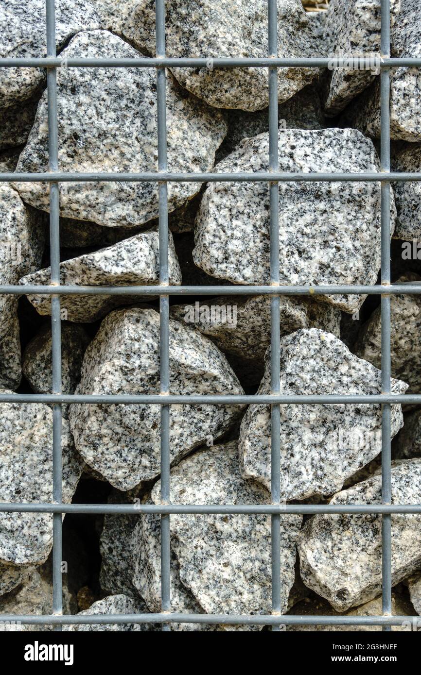 Small rocks or gravel, used for construction within a wire fence Stock ...