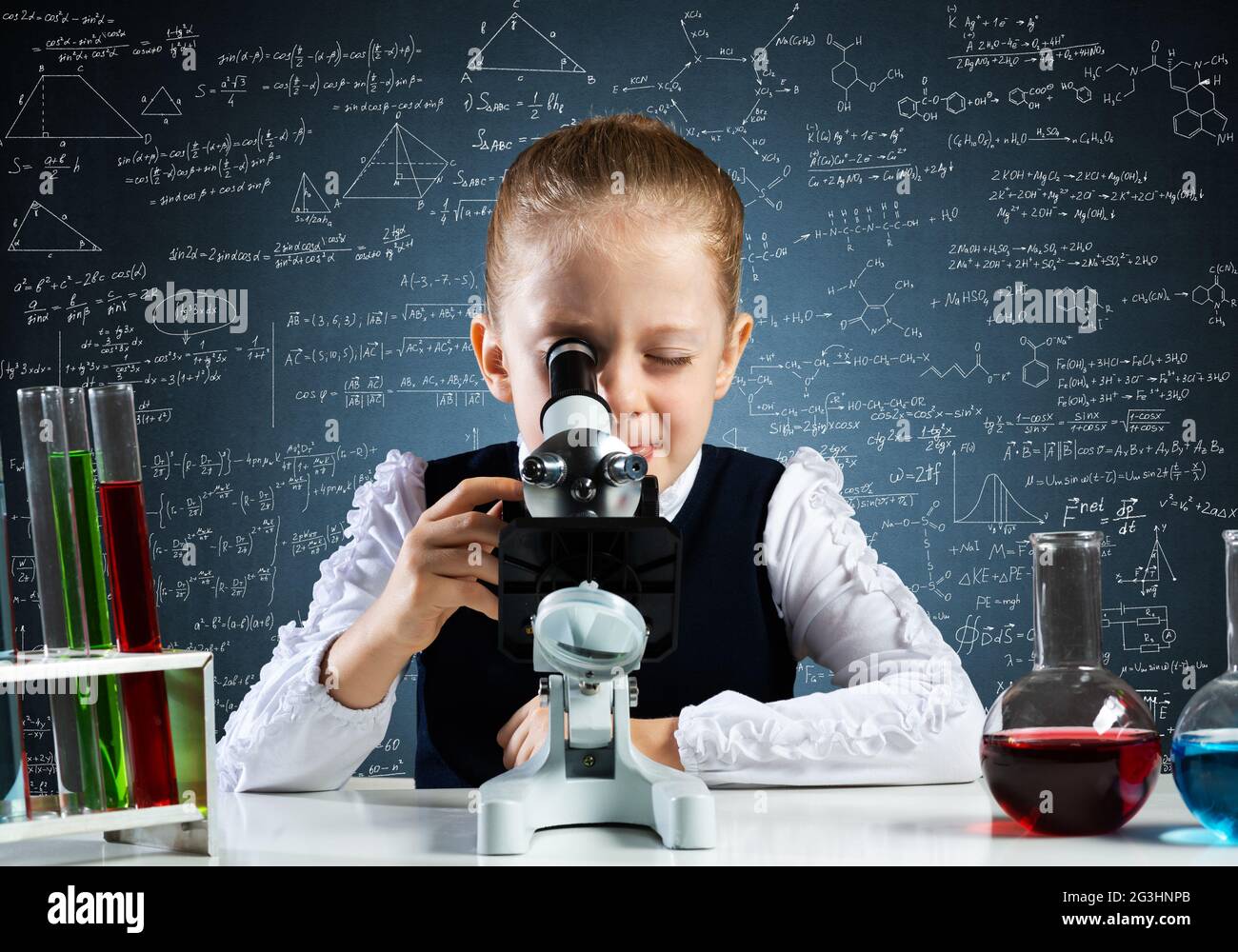 Little girl scientist looking through microscope Stock Photo - Alamy