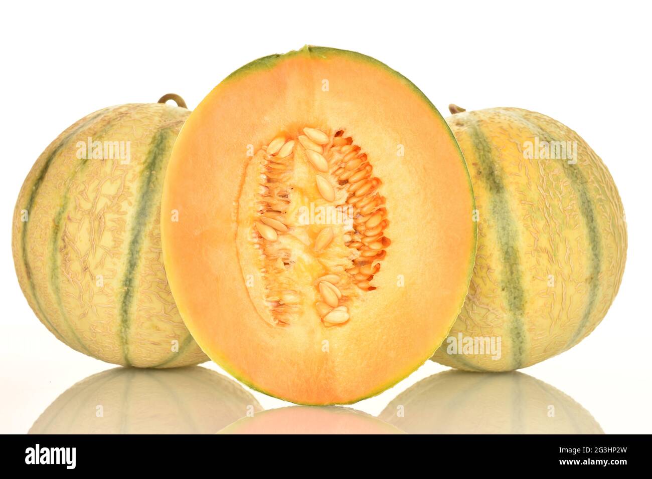 One half and two whole fragrant juicy organic melons, close-up, over ...