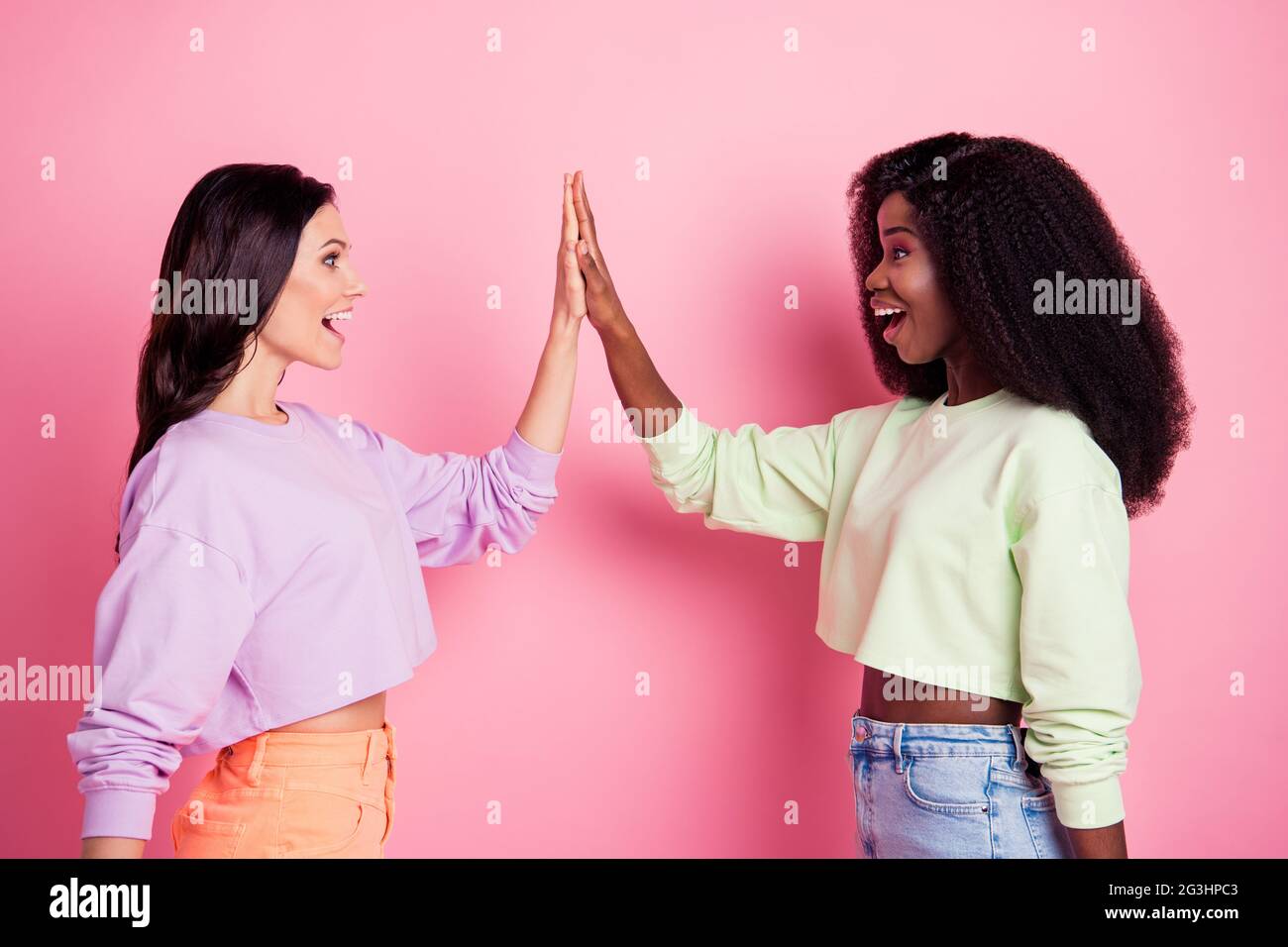 Profile photo of two funny ladies give high five open mouth wear ...