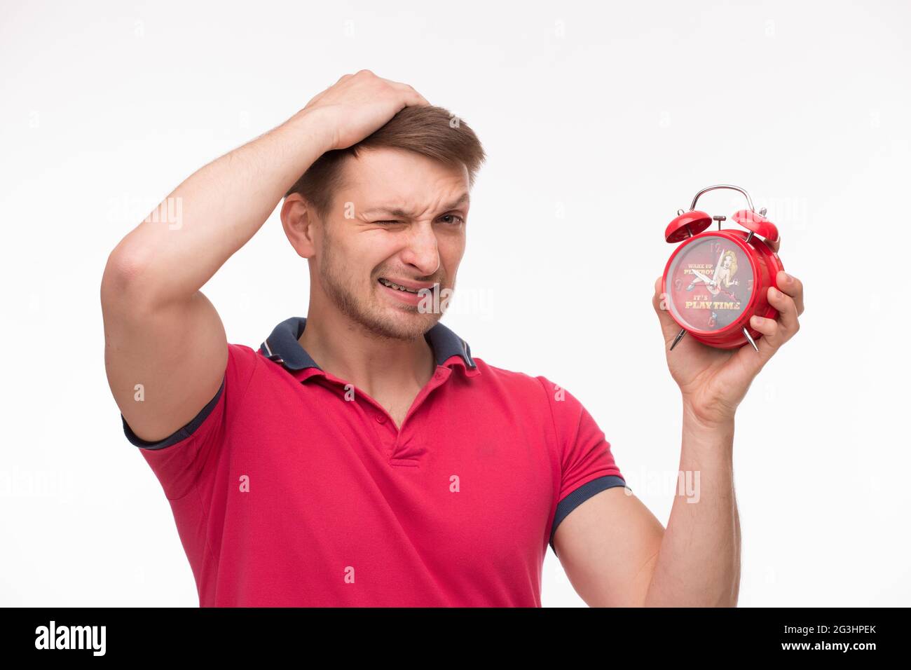 Young man with alarm clock Stock Photo - Alamy