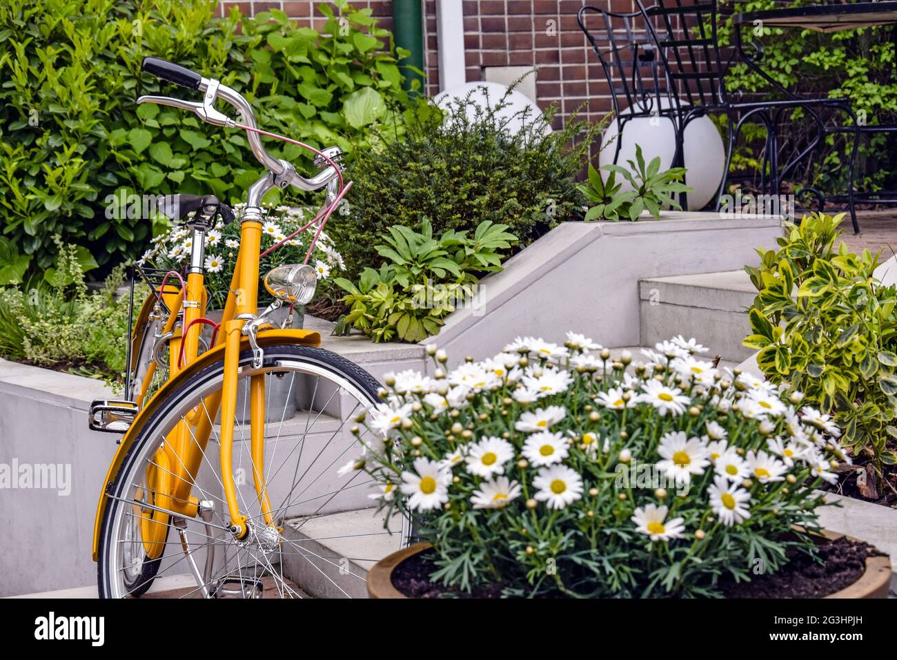 Vintage yellow color bike is parked near cafe on an old street in ...