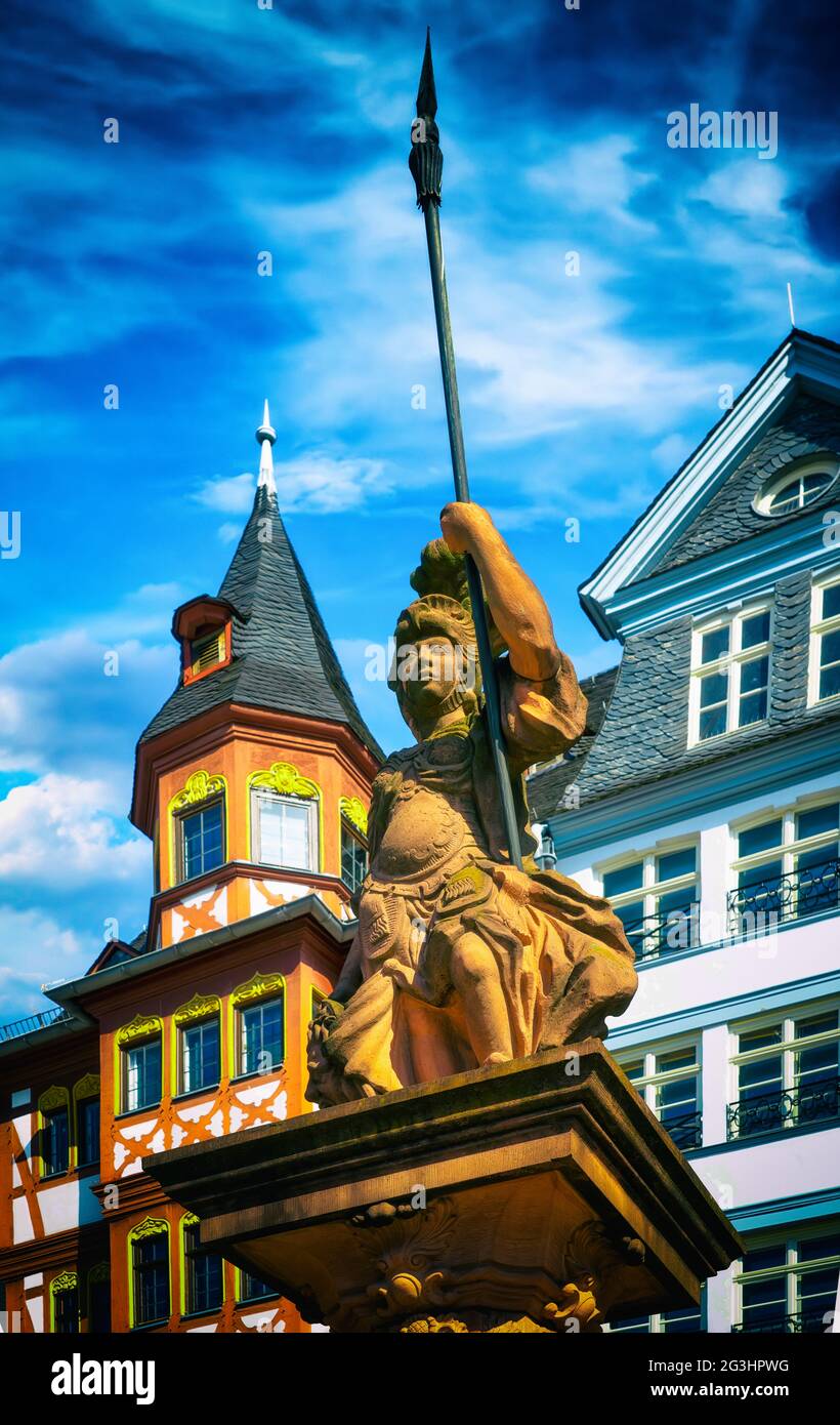 Minerva fountain in front of a beautiful half-timbered facade on the ...
