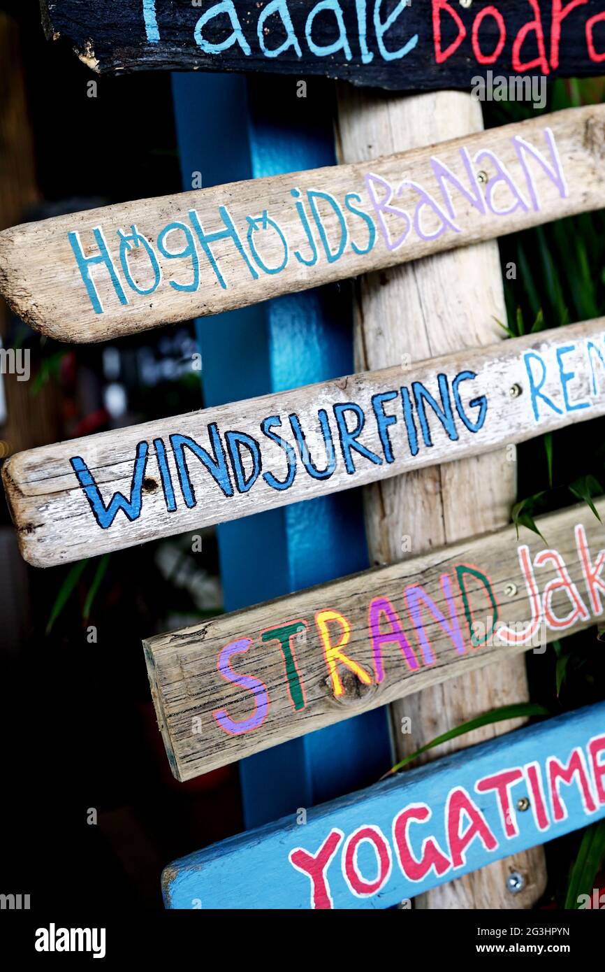 Various signs in a beach restaurant, including yoga and windsurfing ...
