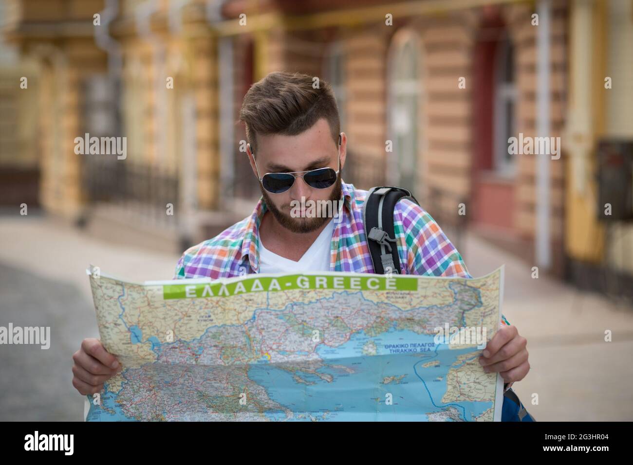 Young man looking map hi-res stock photography and images - Alamy
