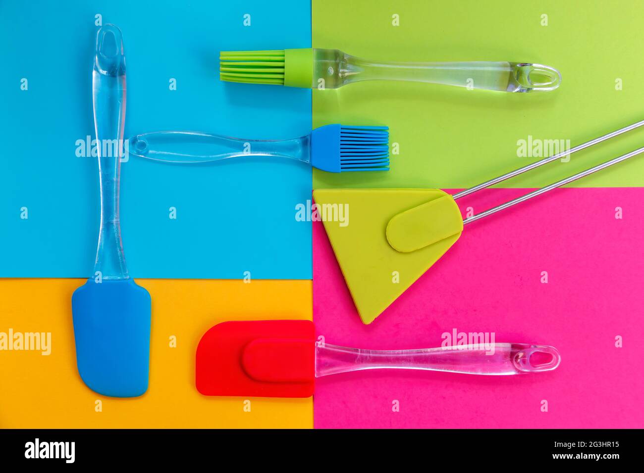 Cooking utensils. Spatulas and silicone brushes on bright colored ...