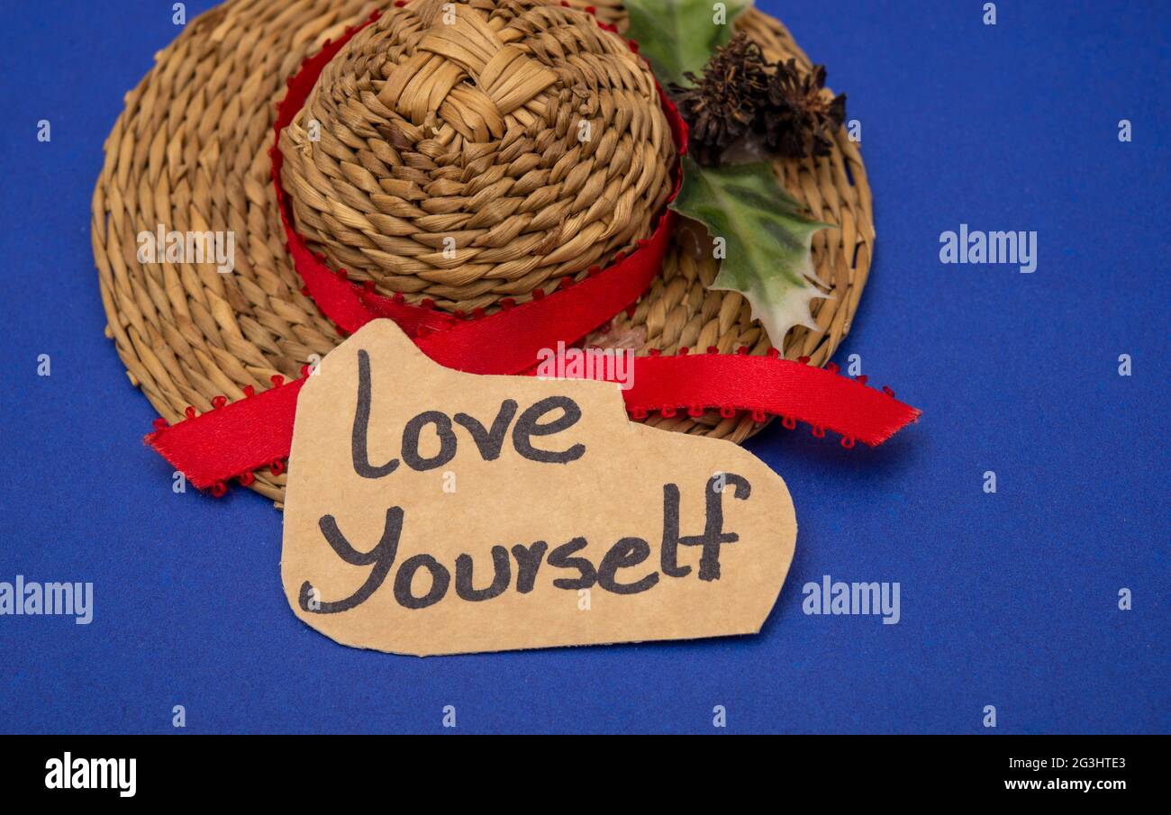 Love yourself hand written note with lady cap in background Stock Photo ...