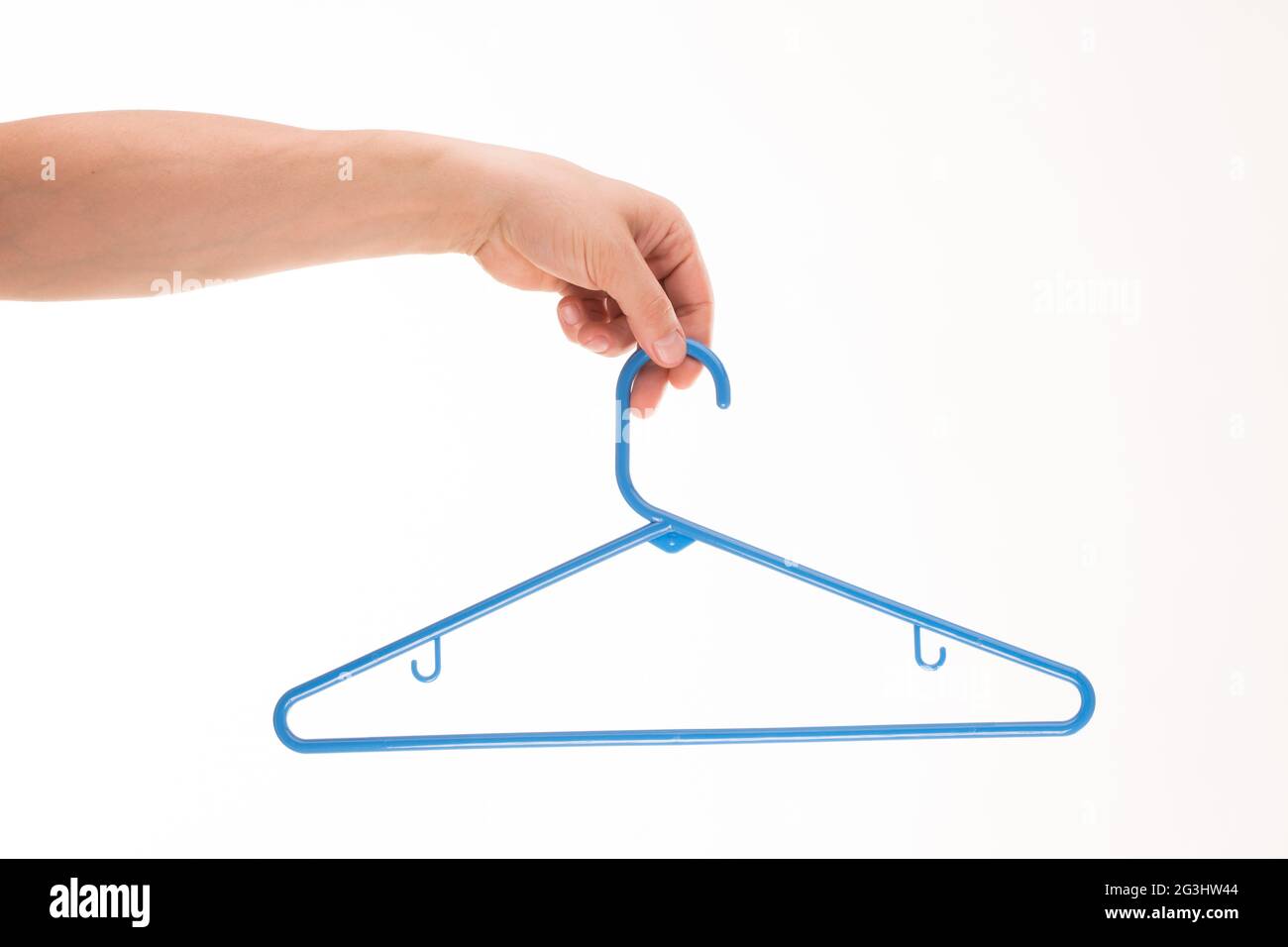 Hand holding hanger Stock Photo - Alamy