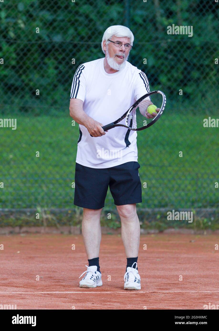 Senior man playing tennis Stock Photo - Alamy