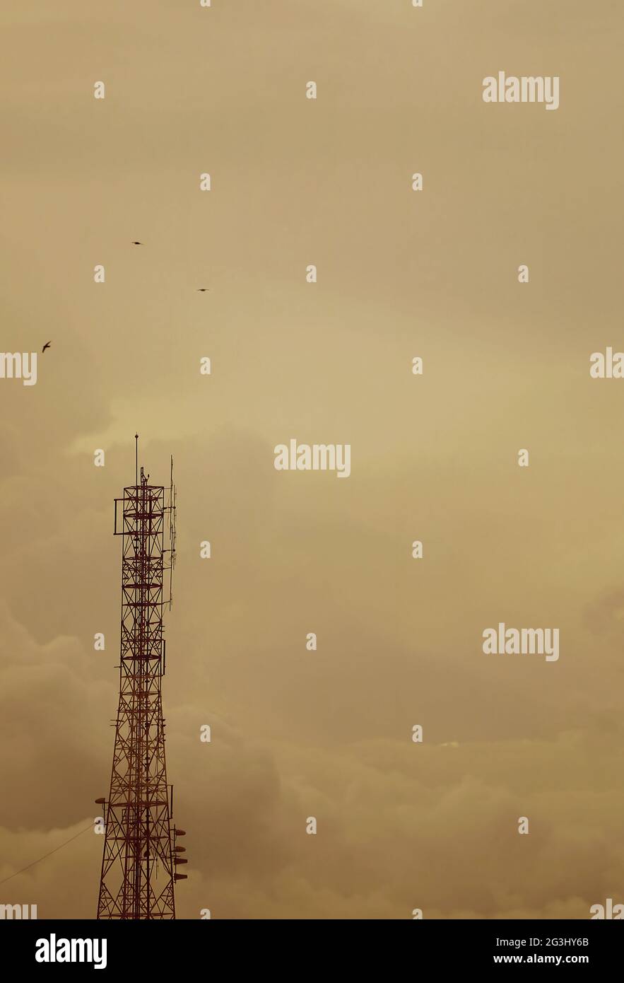 Sepia Image of Telecommunication Tower Against Cloudy Sky Stock Photo ...