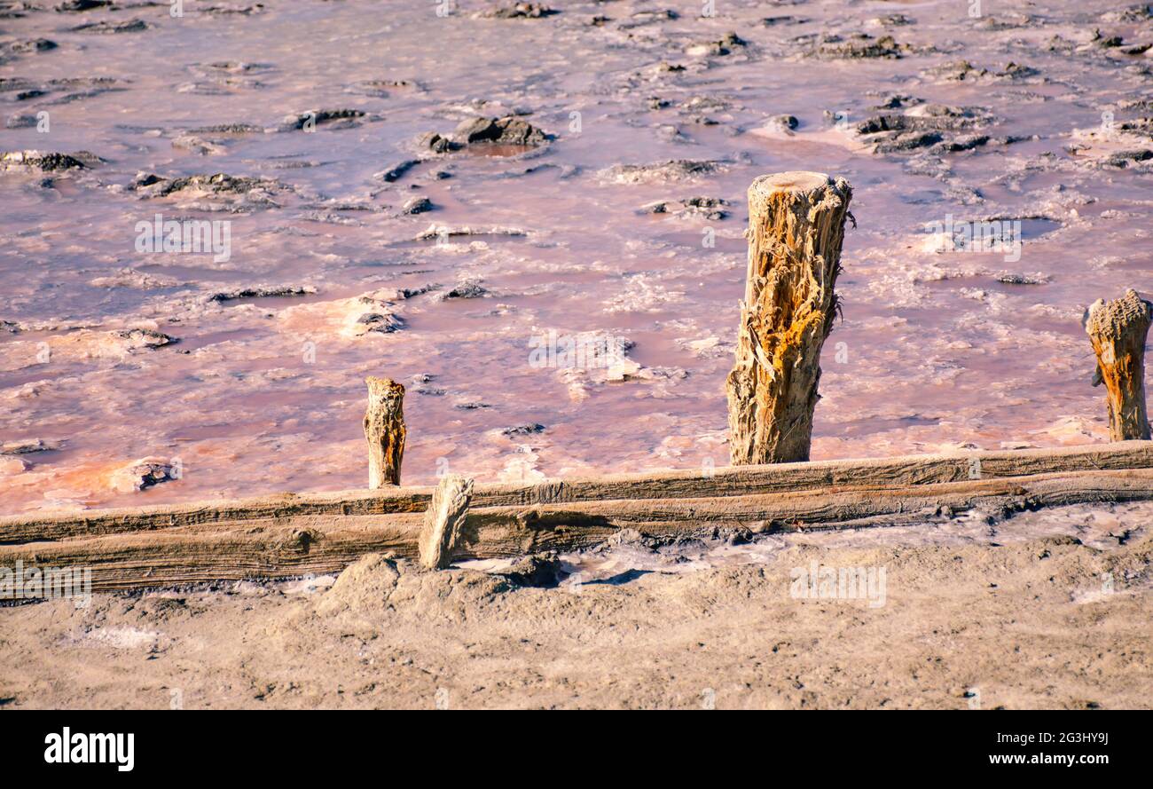 A wooden crumbling post on the lake for the extraction of salt. Salt ...