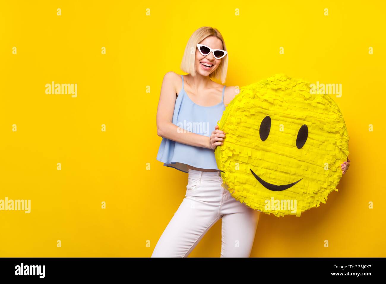 Photo of funky cute blond short hair lady hold pinata wear spectacles ...