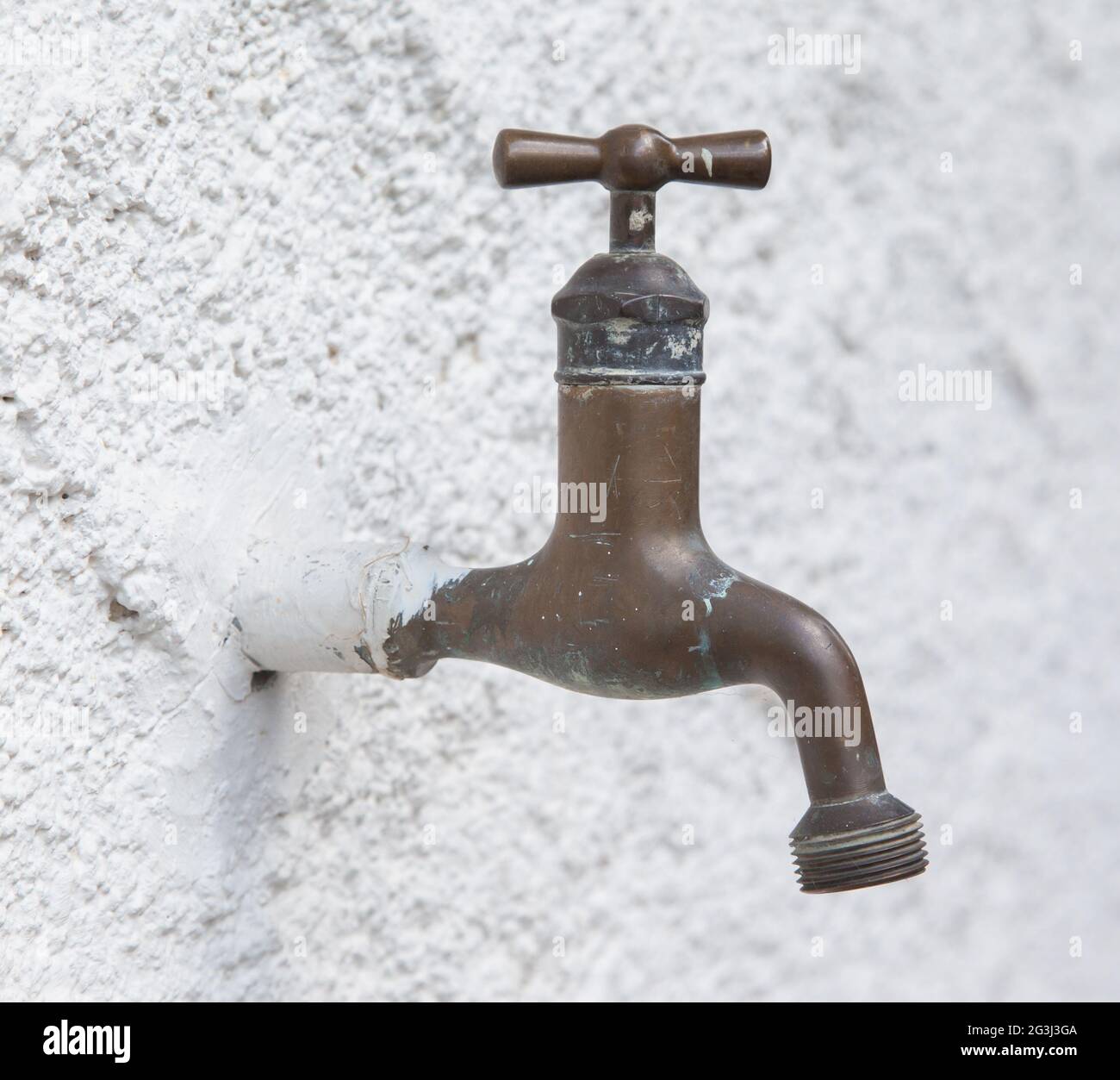 Old water tap on a white wall Stock Photo - Alamy
