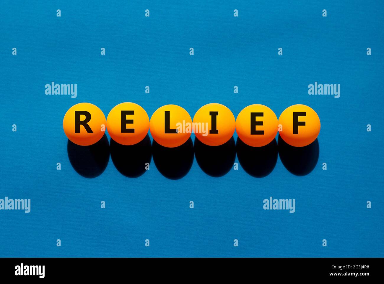 Relief and bonus symbol. The concept word 'relief' on orange table ...