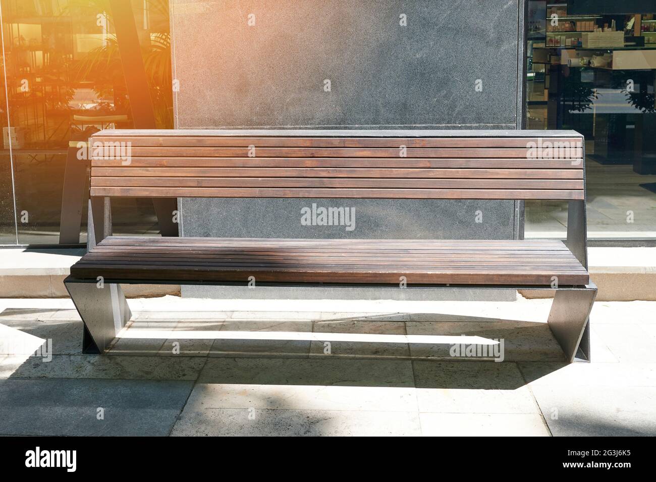 Modern wooden empty bench outside in citywindows and marble background ...