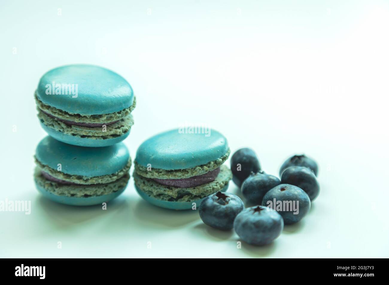 Blueberry flavored macaroons in white background Stock Photo - Alamy