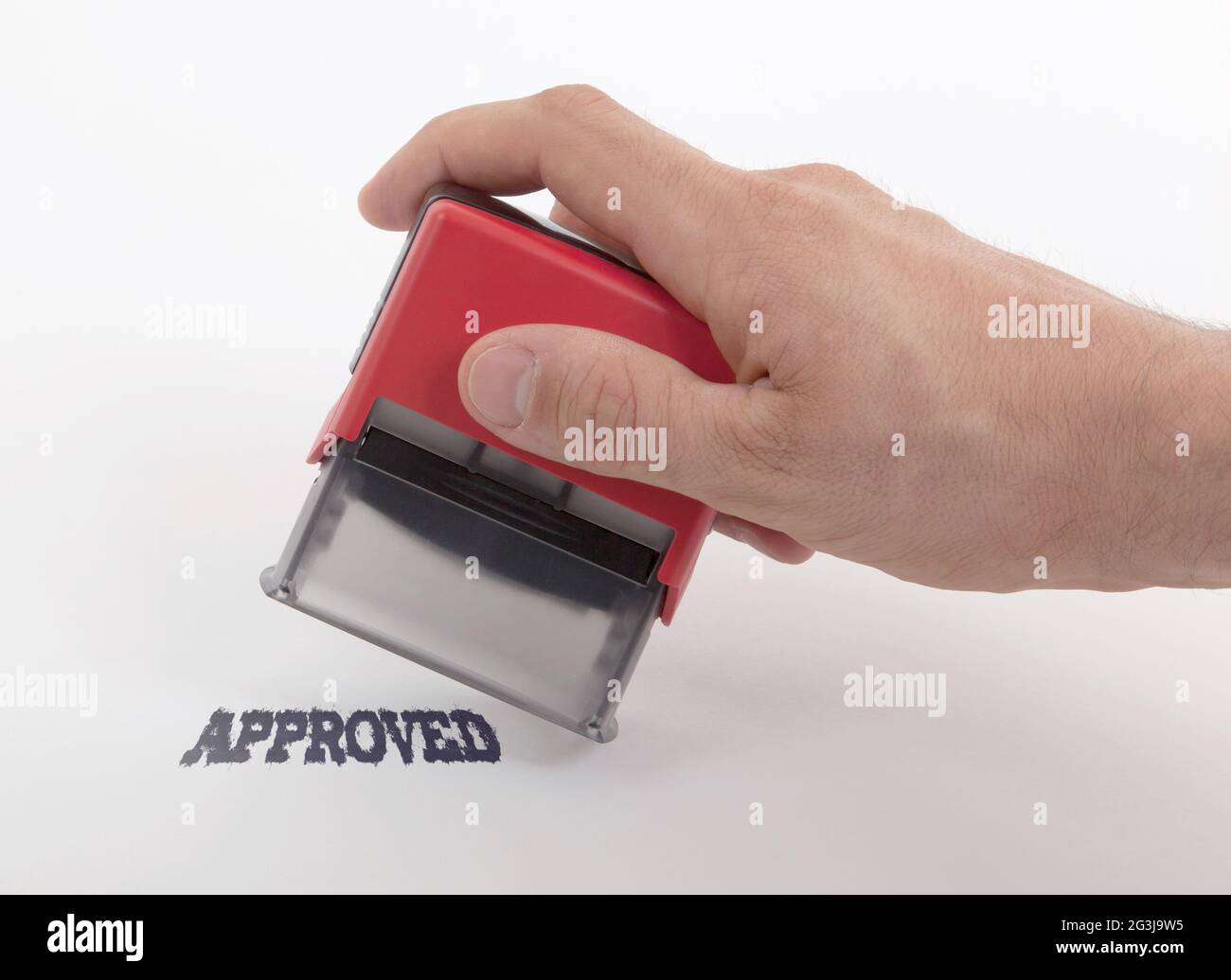 Plastic stamp in hand, isolated Stock Photo - Alamy