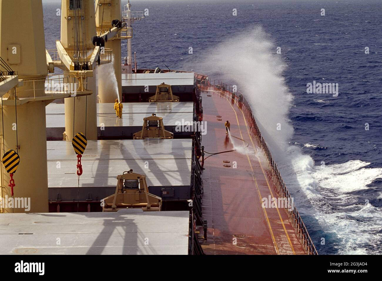 After leaving port, the crew washes the cargo residues left on the deck ...