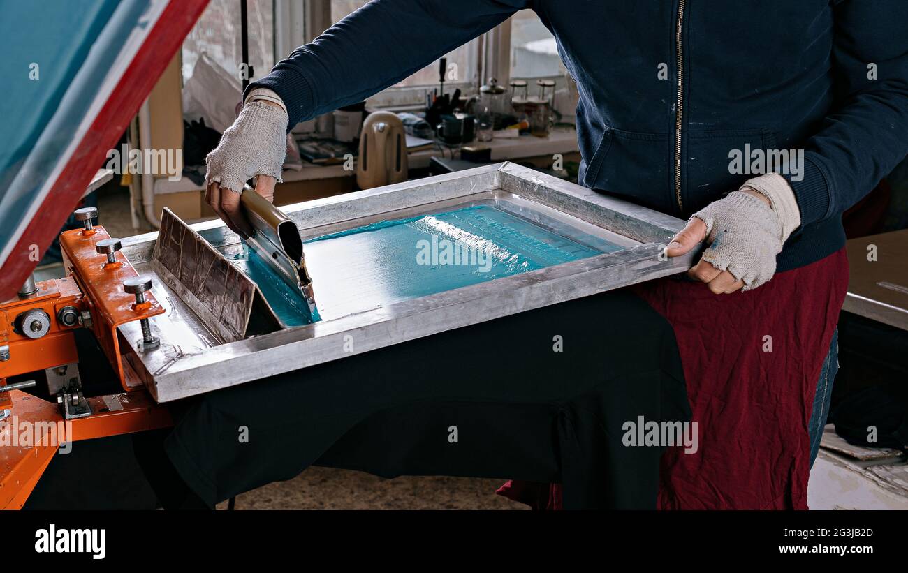 selective focus photo of male hands with squeegee. serigraphy ...