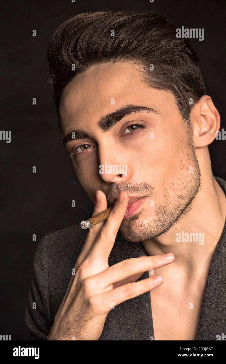 Model man smoking in studio Stock Photo - Alamy