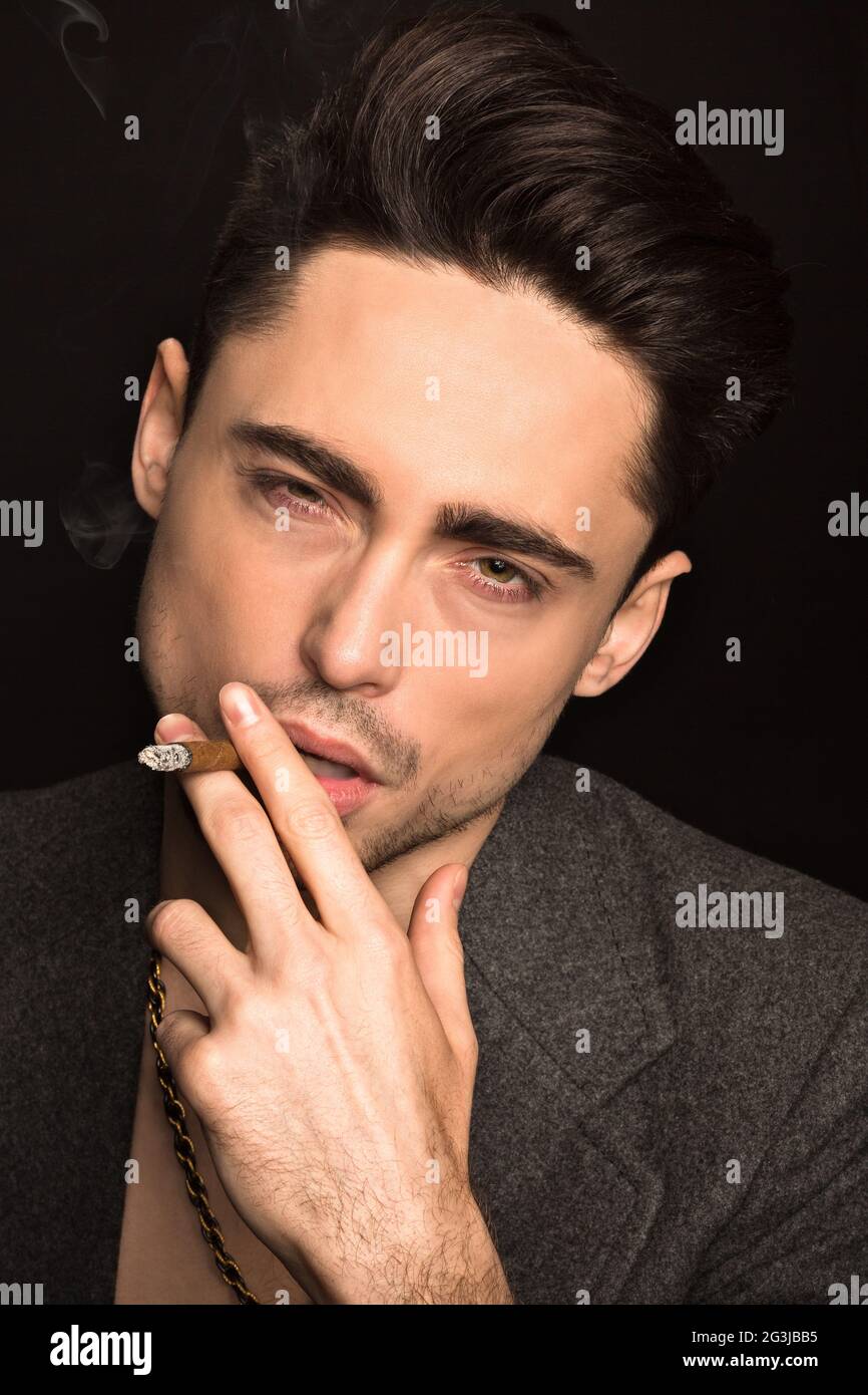 Model man smoking in studio Stock Photo - Alamy