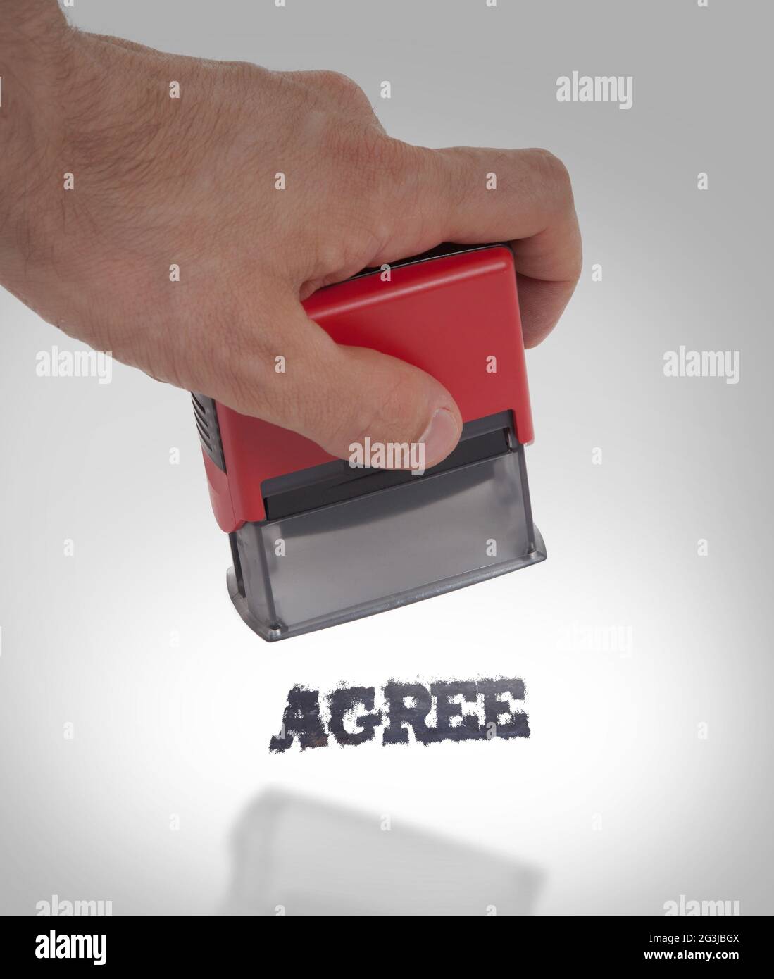 Plastic stamp in hand, isolated Stock Photo - Alamy