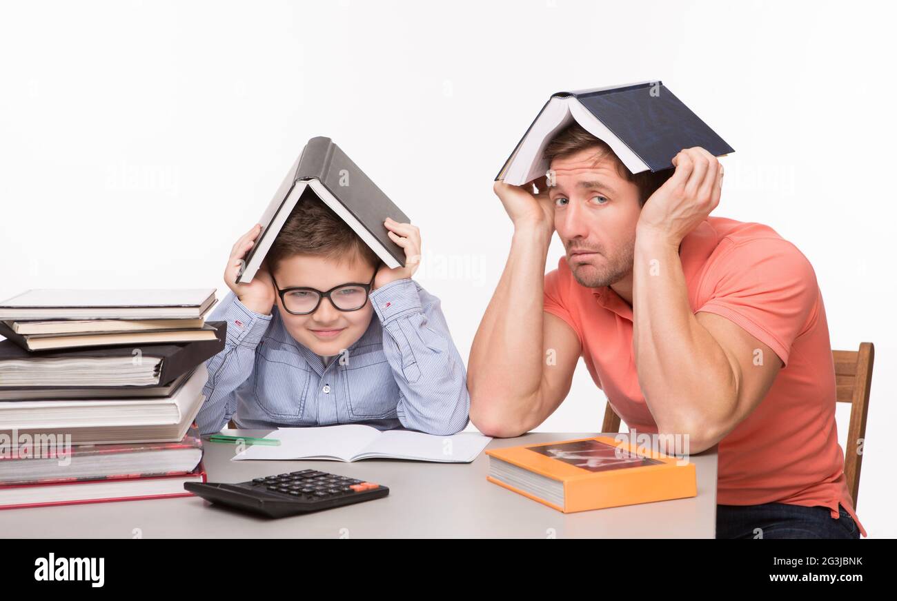 Father and son hiding under books Stock Photo - Alamy