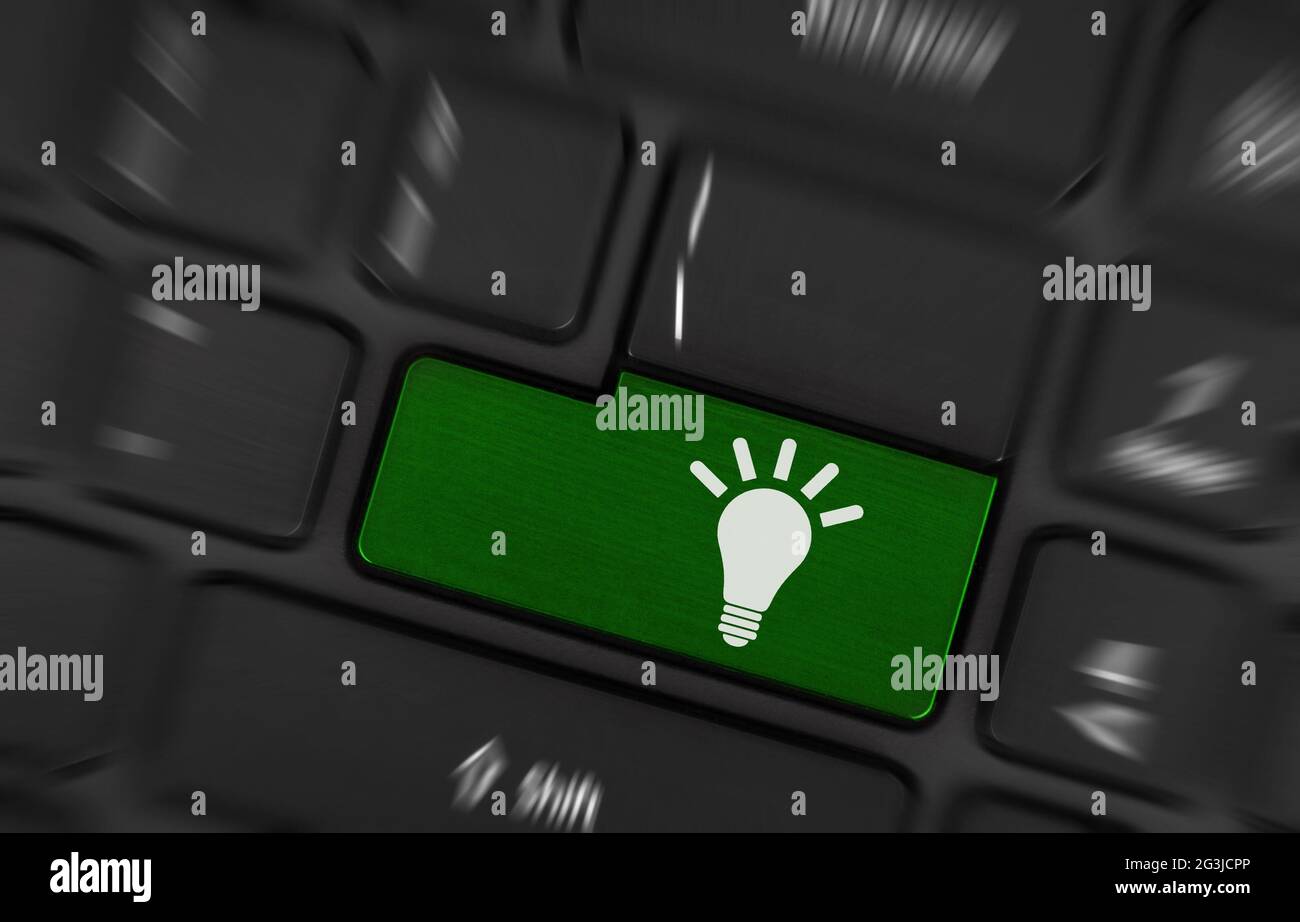 Laptop keyboard with light bulb symbol Stock Photo - Alamy