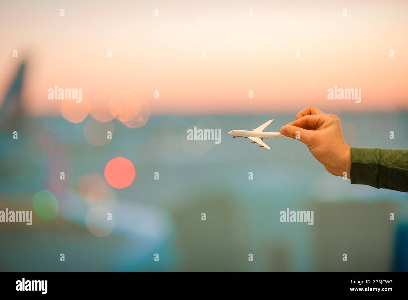 Close up hand holding an airplane model Stock Photo - Alamy