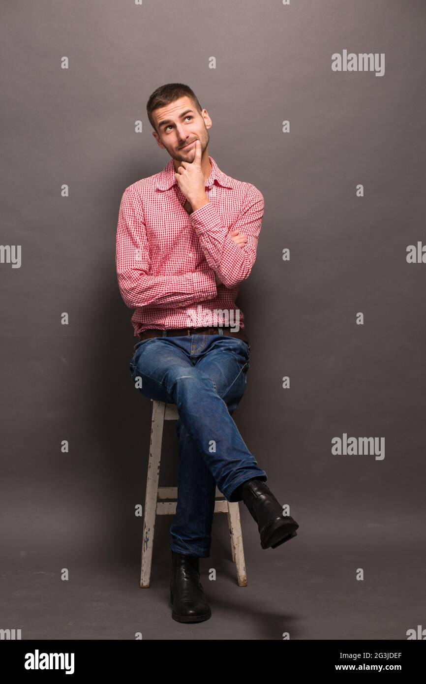 Thoughtful man in studio Stock Photo - Alamy