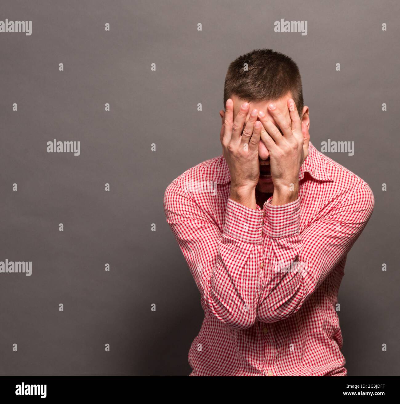 Man covering eyes his face Stock Photo - Alamy