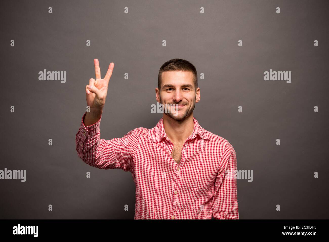 Handsome man showing okay sign Stock Photo - Alamy