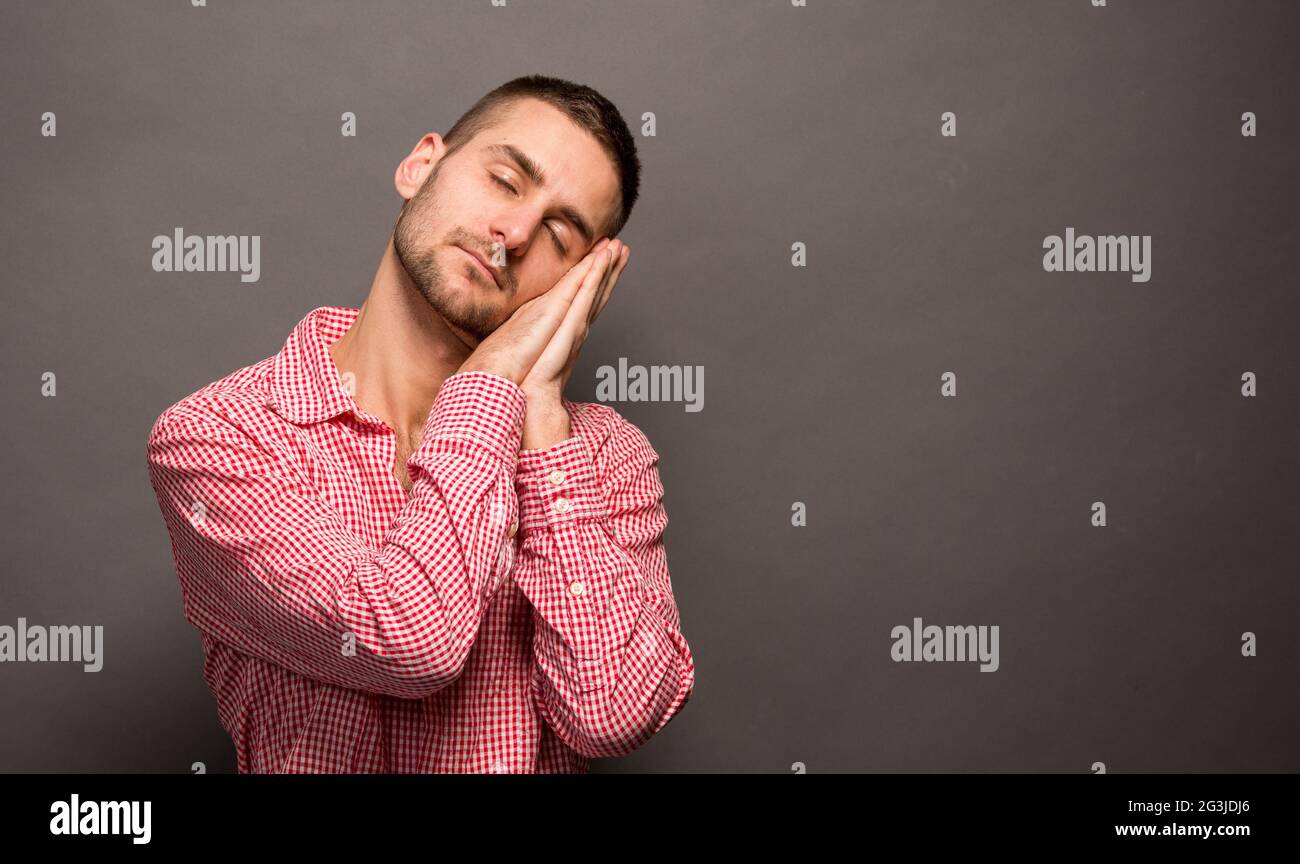 Sleepy man in studio Stock Photo - Alamy
