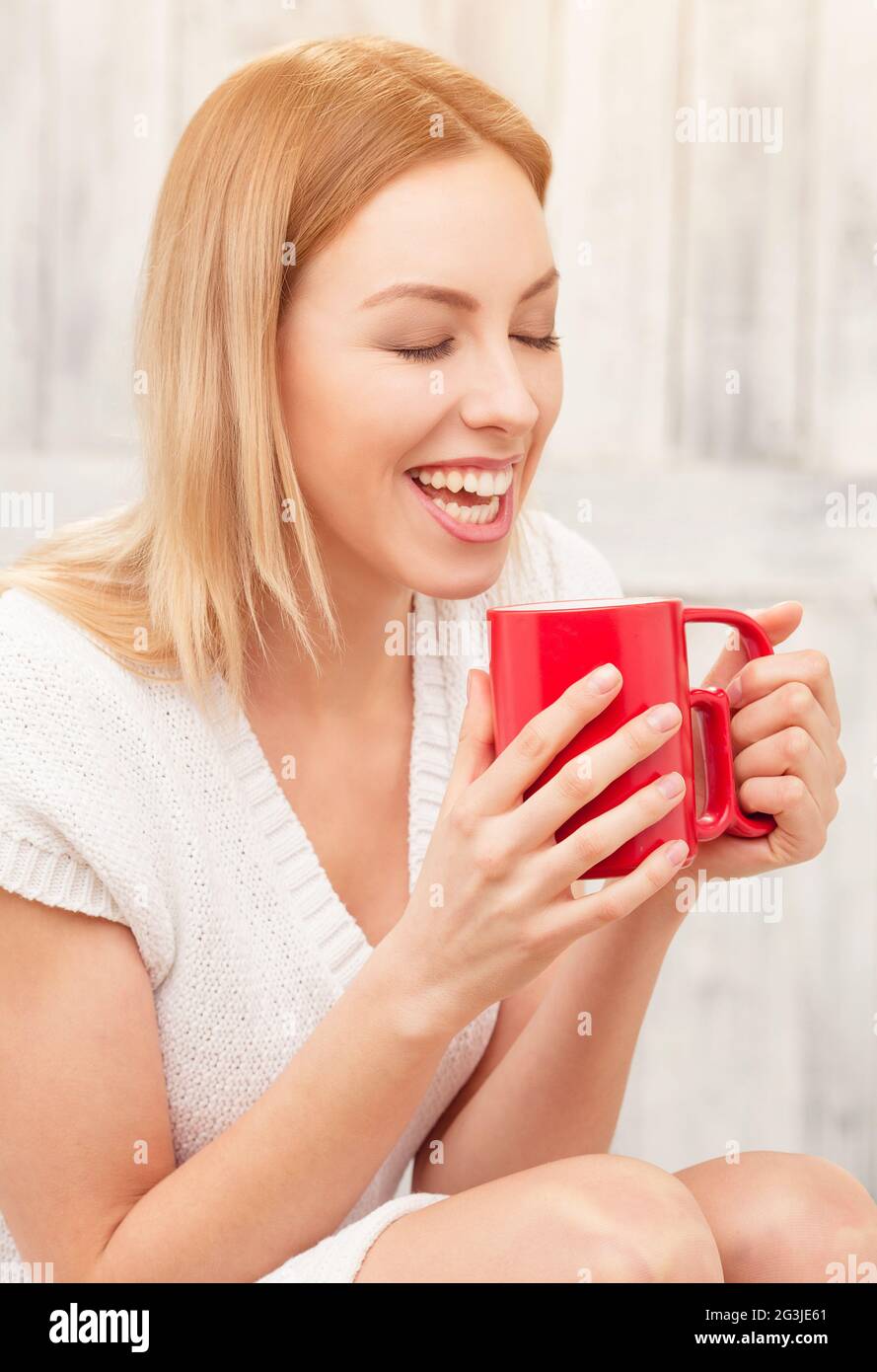 Lady with a cup of tea indoors Stock Photo - Alamy