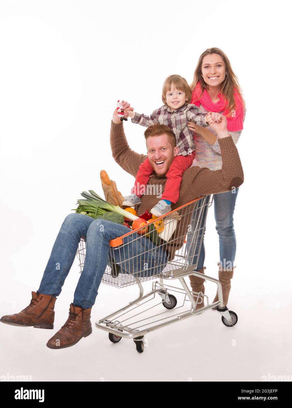 Happy family with a shopping cart in supermarket Stock Photo - Alamy
